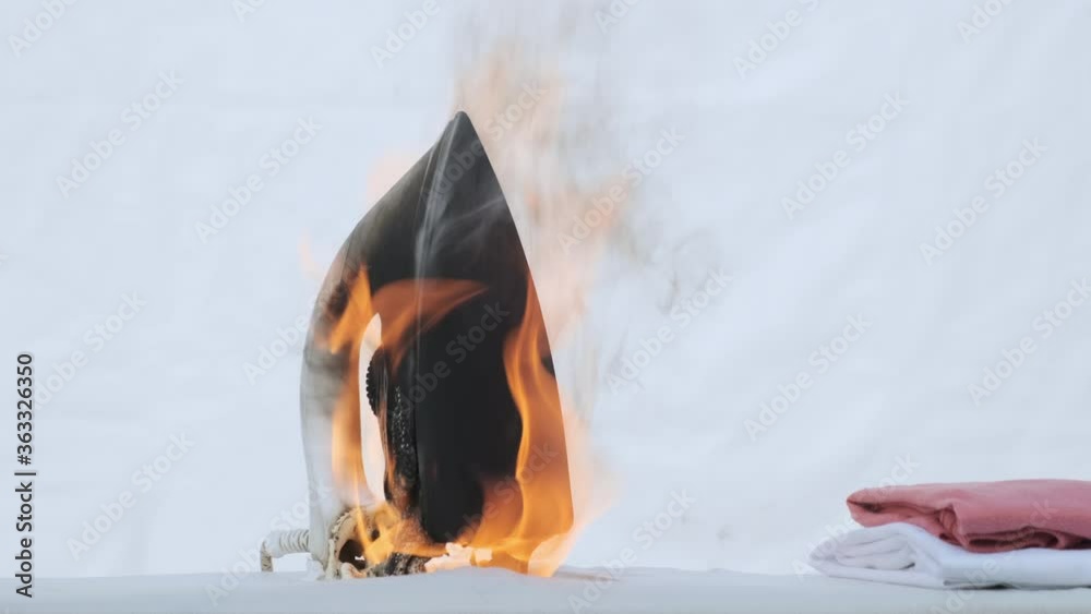 beginning of house fire, burning iron in flame falls from ironing board ...