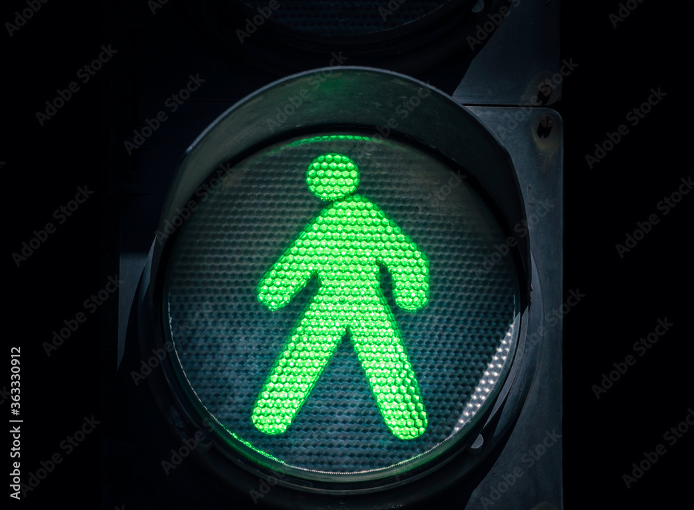 traffic light with a green man on a black background Stock Photo ...