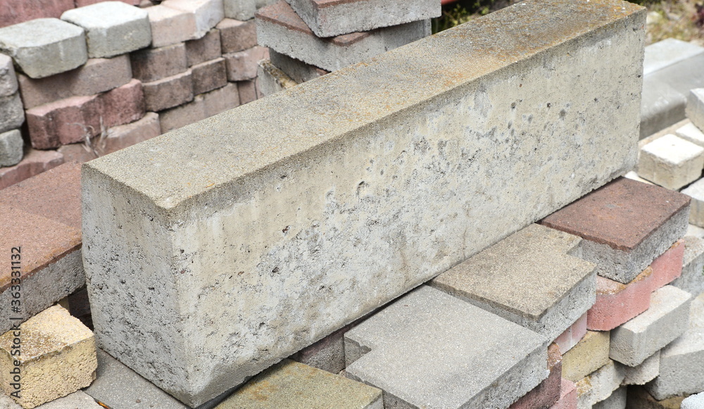 Stack of gray paving slabs. Laying the sidewalk of the tiles ...