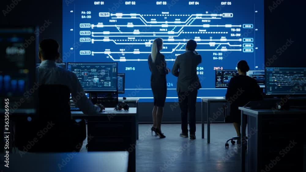 Project Manager and Computer Science Engineer Talking while Using Big Screen Display Showing ...