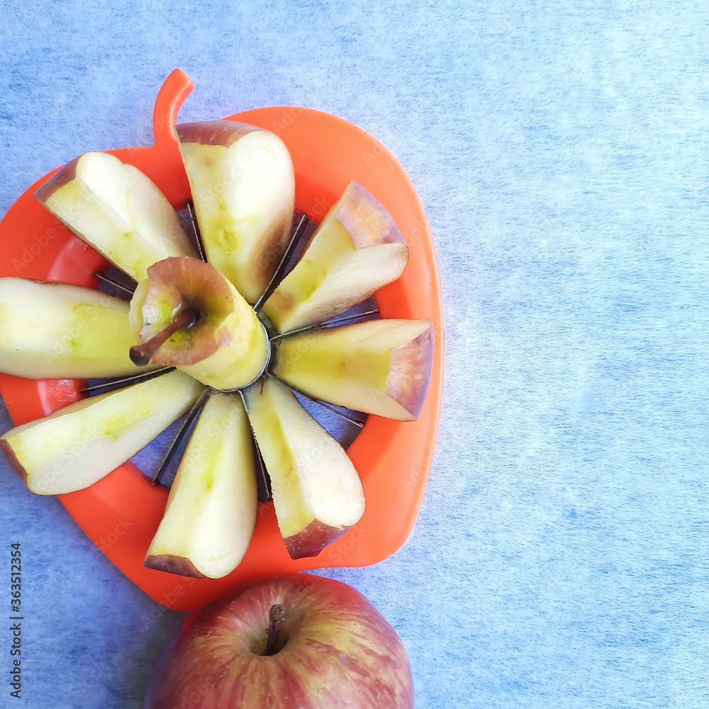 Apple shown beautifully in apple cutter like flower shape and it tempts ...