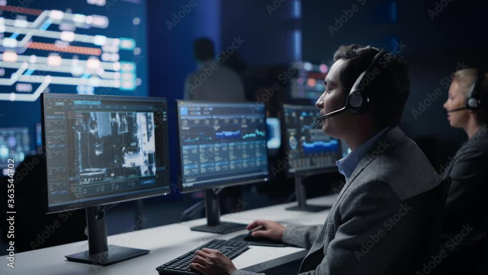 Confident Male Cyber Security Specialist Wearing Headset Works on ...