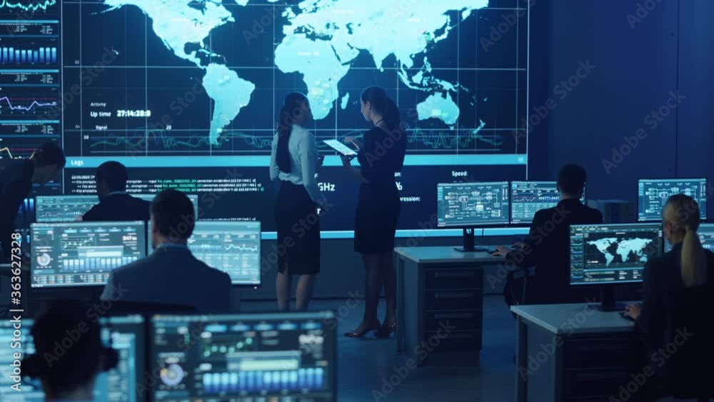 Project Manager and Computer Science Engineer Talking while Using Big Screen Display Showing ...