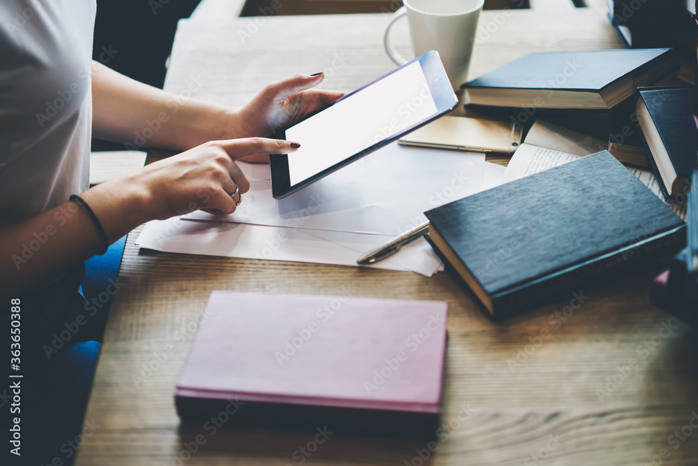 Cropped image of female hands holding modern touchpad with mock up copy ...