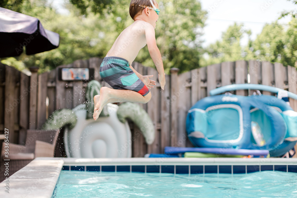 Little boy jumping into pool Stock Photo | Adobe Stock