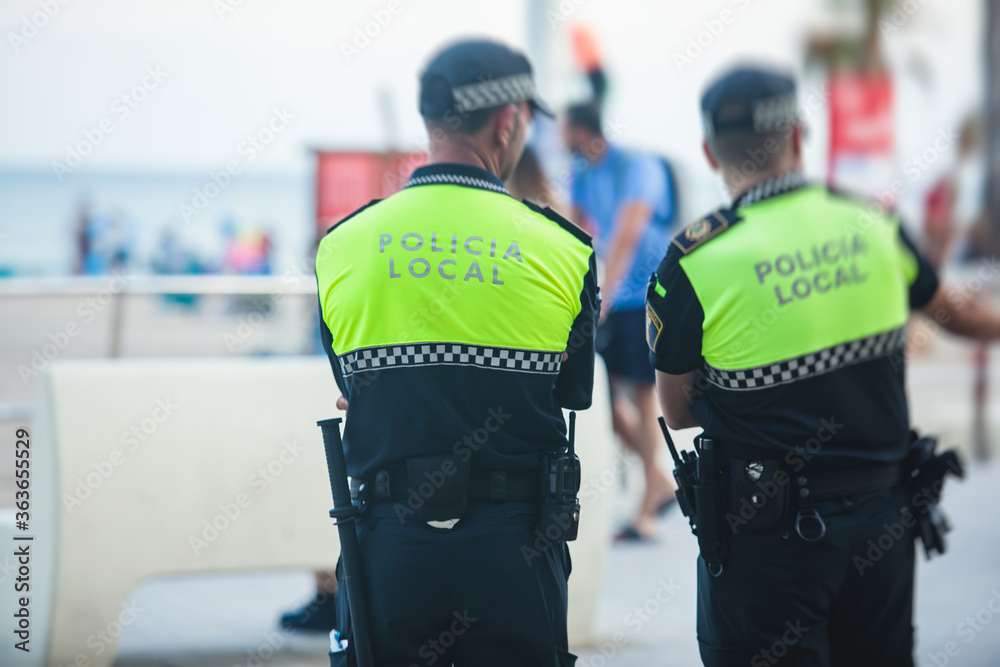Spanish police squad formation back view with "Local Police" logo ...