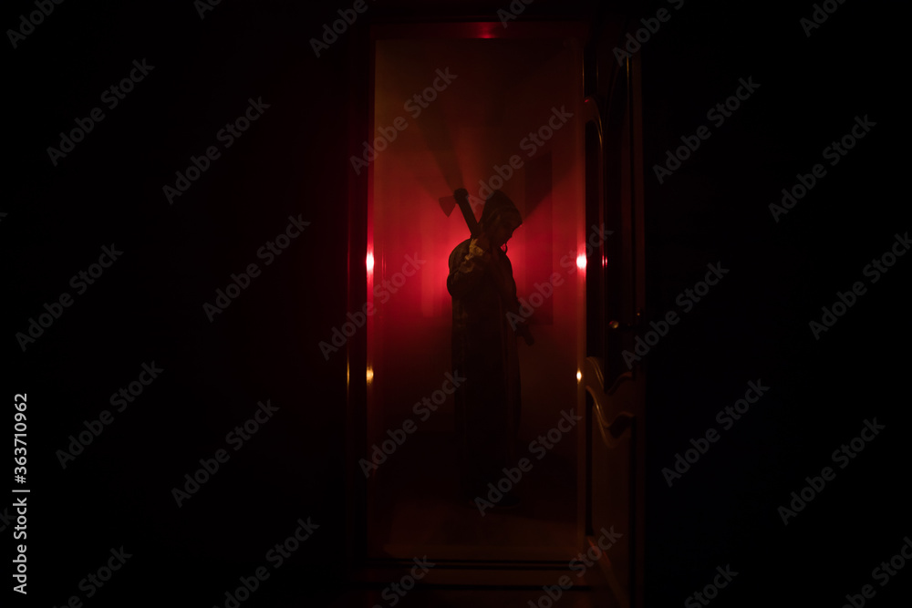 Silhouette of an unknown shadow figure on a door through a closed glass ...