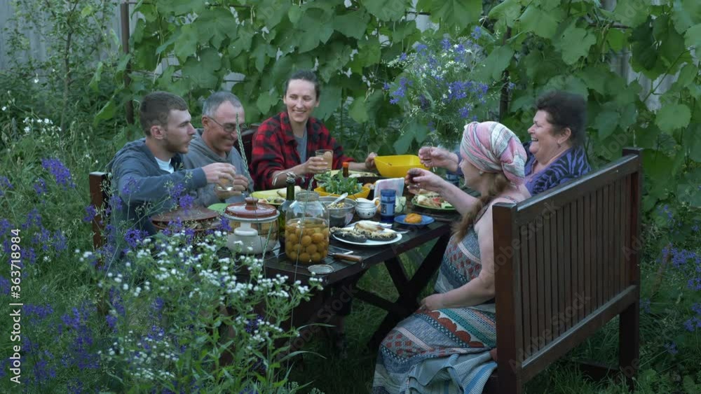 Gathered together relatives and friends at picnic outdoor. Young and ...