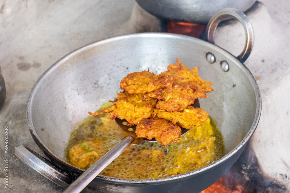 Kofta (Fried Crispy Pakoda) deep fried in oil in pan on traditional ...