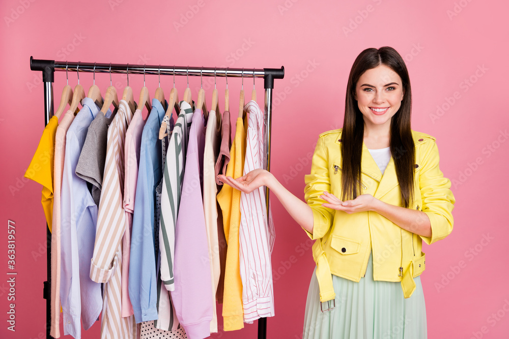 Photo of charming confident shop assistant lady showing arms cloths ...
