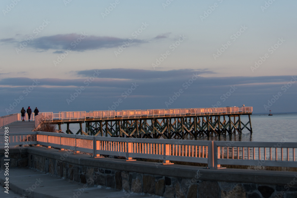 Beautiful golden hour light on the long pier and the Long Island Sound ...