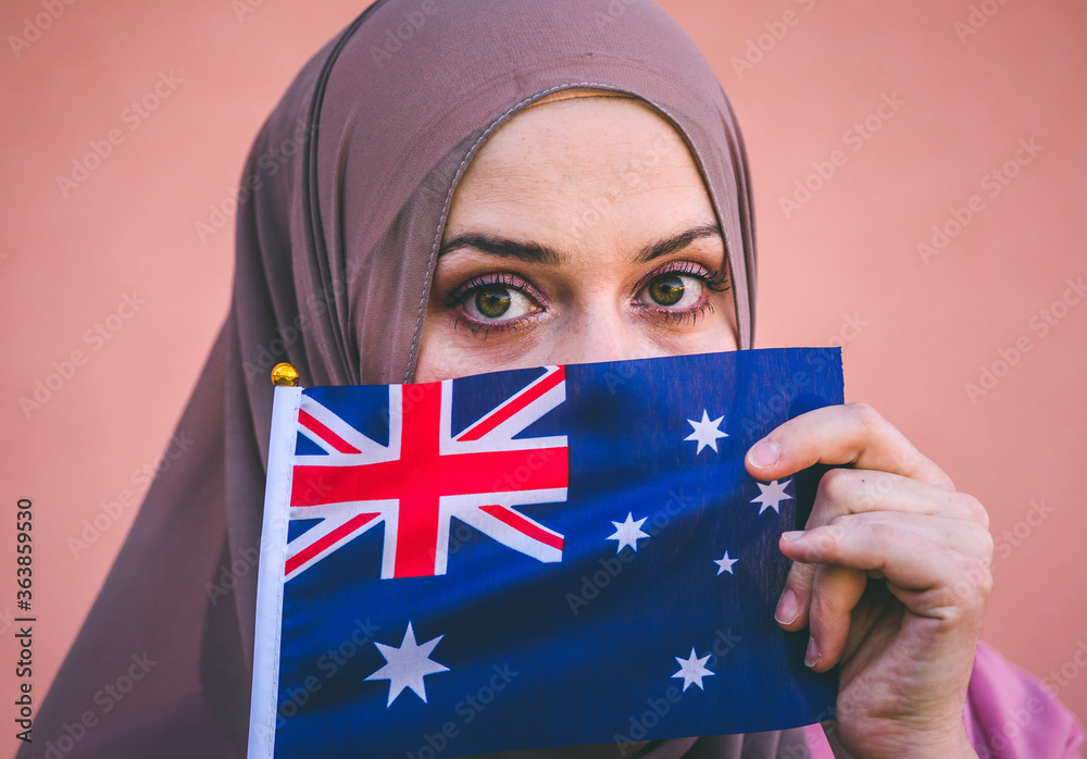 Muslim woman in hijab holds flag of Australia Stock Photo | Adobe Stock