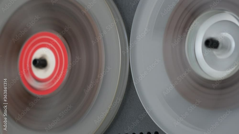 Vintage reel to reel tape recorder playing music. Spinning reels on old ...