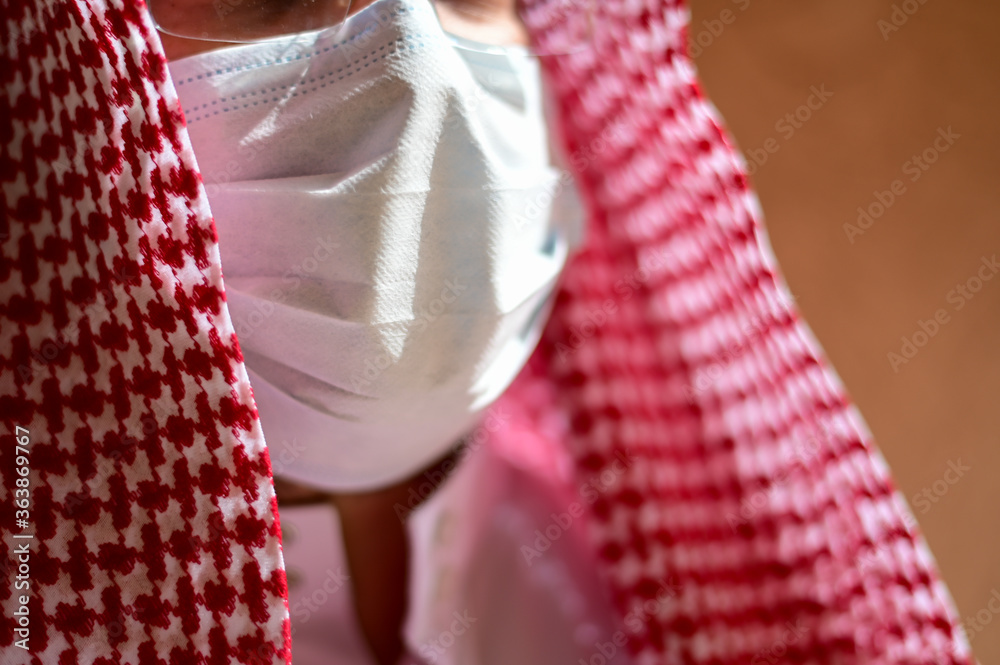 Arabic man from Saudi Arabia wearing traditional clothes using face ...