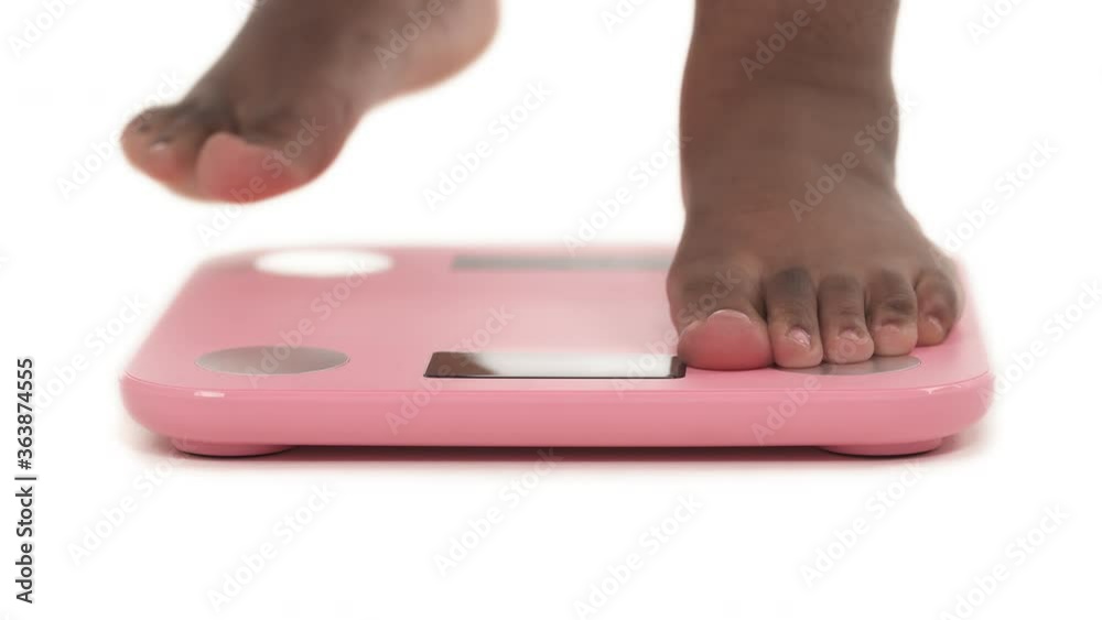 close-up portrait of black plus size woman's legs, demonstrating weigh ...