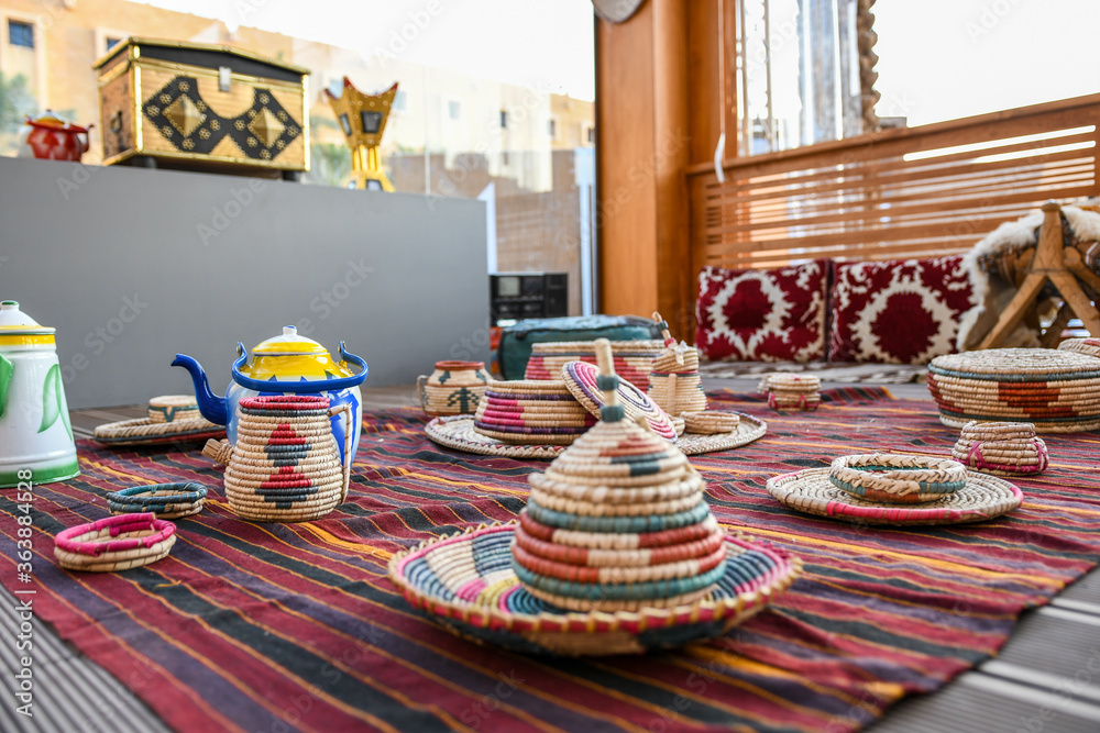 Traditional Arabic food sitting board or bench, tea pot and some hand ...