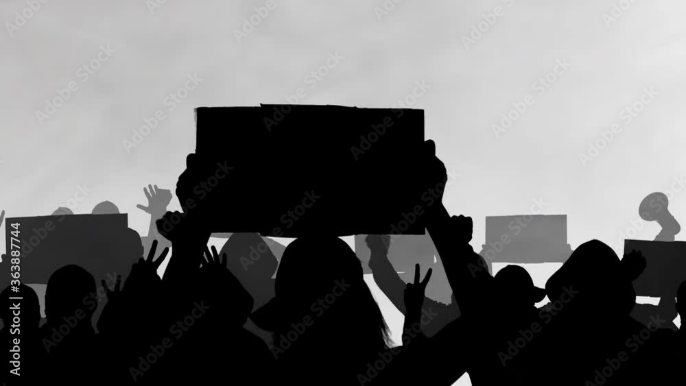 Crowd raising banners and clenched fists on street BLM. Silhouettes of ...