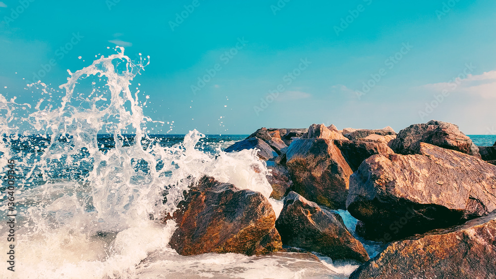 Seascape of waves breaking on rocky beach. Sea waves crash and splash ...