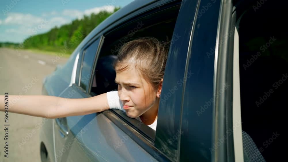 Happy girl kid child leaned out of a car window. happy family journey ...