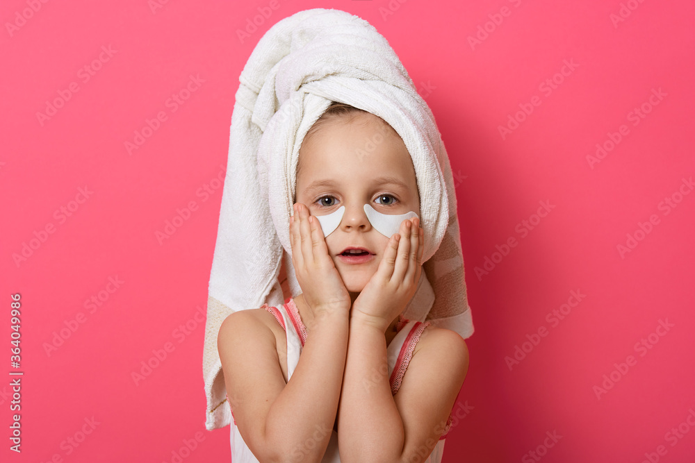 Little cute girl wearing white towel on head, posing with patches under ...