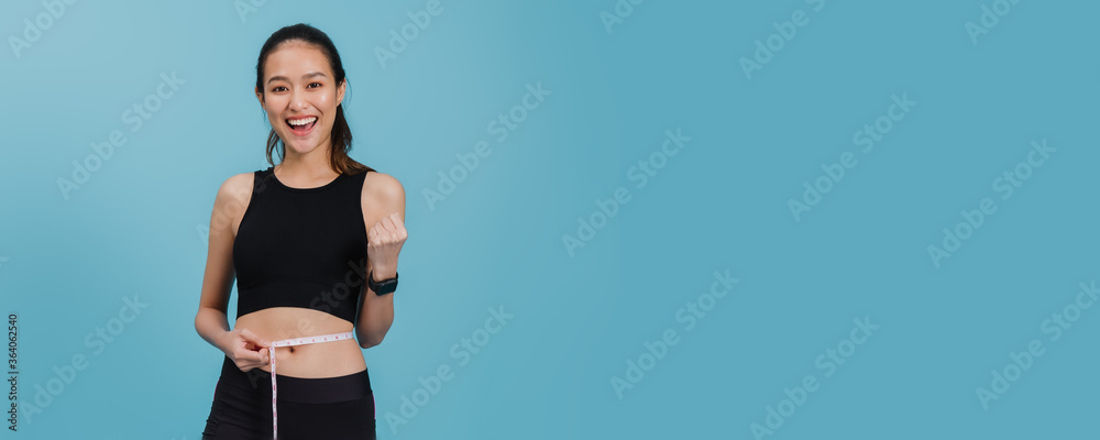 Portrait of confident beautiful asian fitness woman standing and use ...