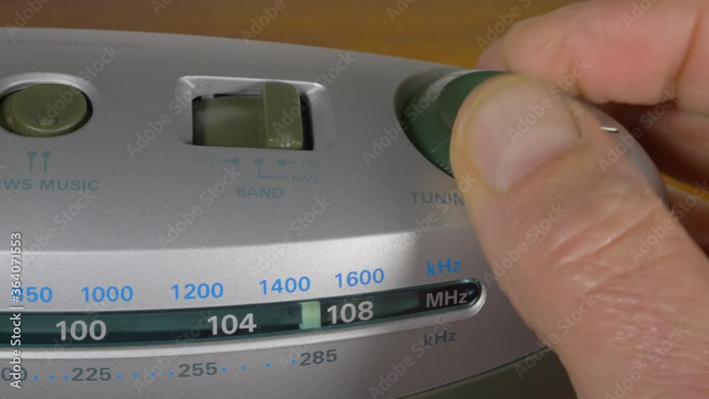 Close POV shot of a man’s hand switching the receiver band on a ...