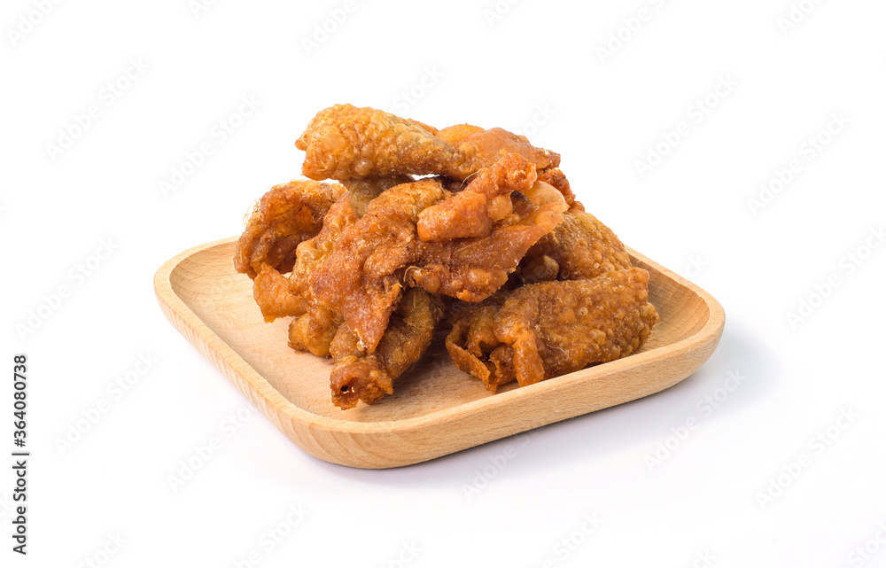 Crispy fried chicken skins on wooden plate. Fried chicken skin on white ...