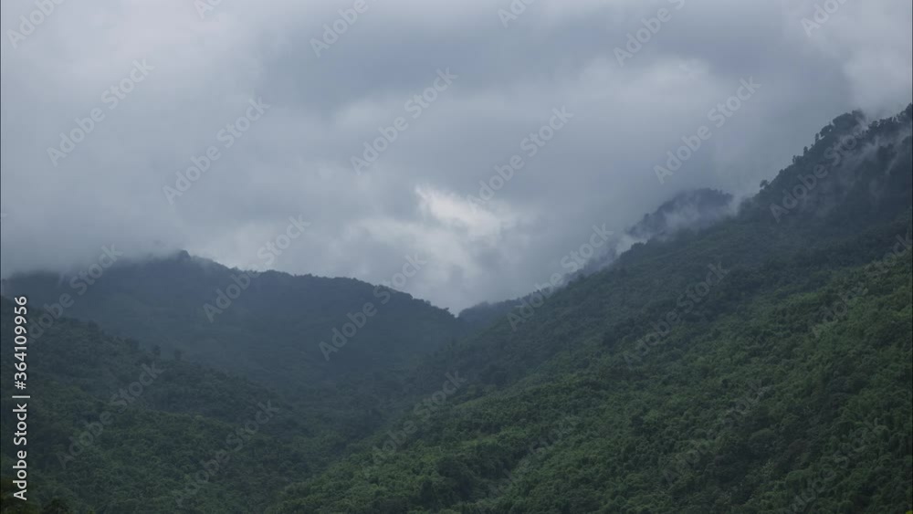 Time-lapse of Cloud Dispersing between two mountains in a Valley with ...