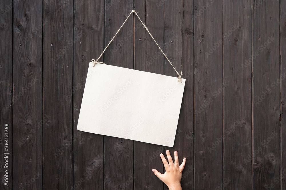 Foto de a white empty advertising sign hangs on a string the right side ...