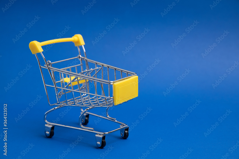 Yellow shopping cart or trolley and small , Product box, Package box ...