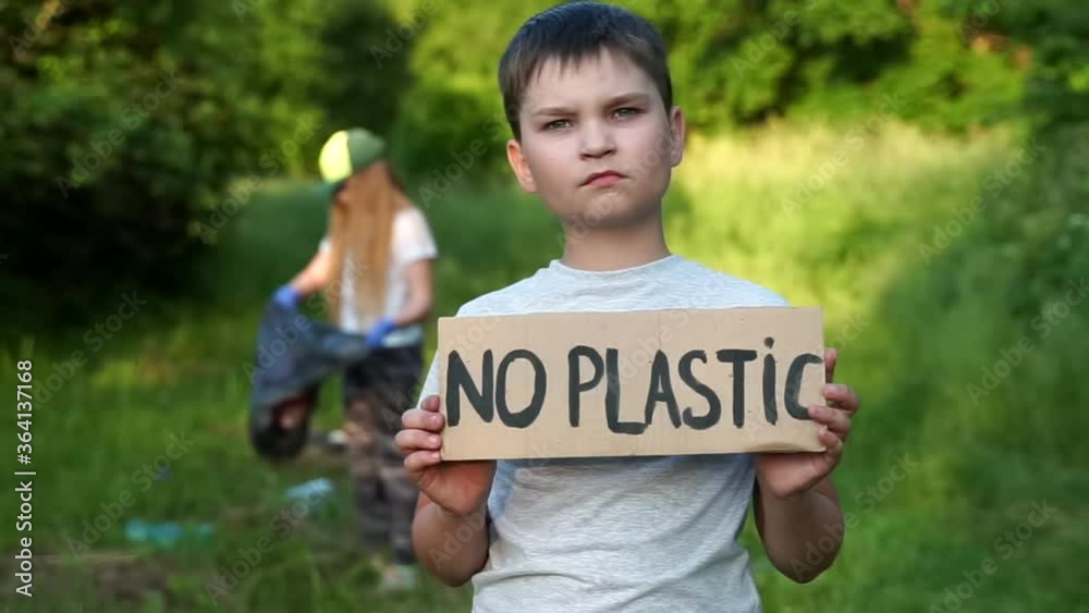 Video Stock kid boy holding No Plastic poster looking to camera ...