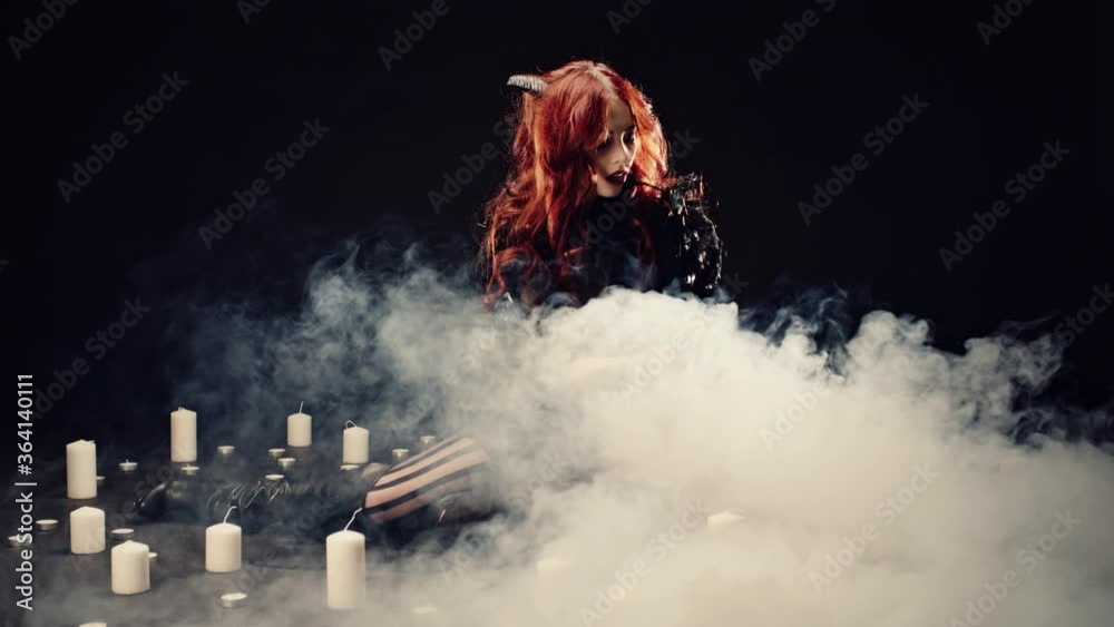 Vidéo Stock Candles placing around female demon, smoke rising in the ...