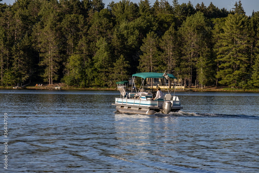 pontoon boat cruising on lake Stock Photo | Adobe Stock