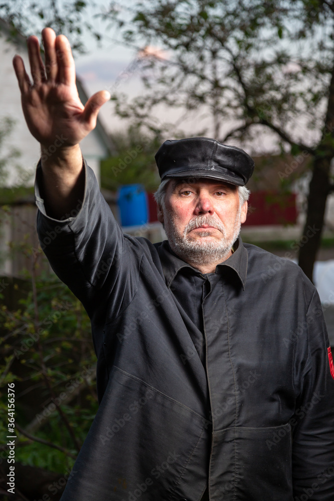 Serious elderly man with black old-fashioned old clothes and a leather ...