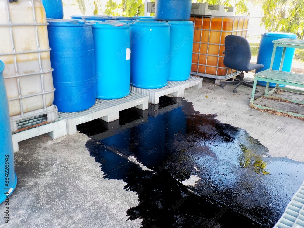 Black liquid chemicals leaking from the tank into the floor. Stock 写真 ...