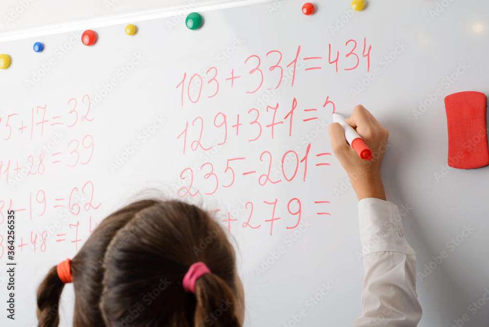 Lesson of math in conventional school. Female learner counting big ...