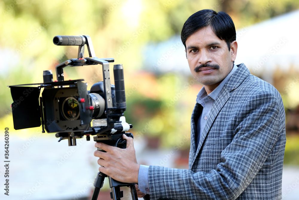 Professional Indian journalist and cameraman recording video or ...