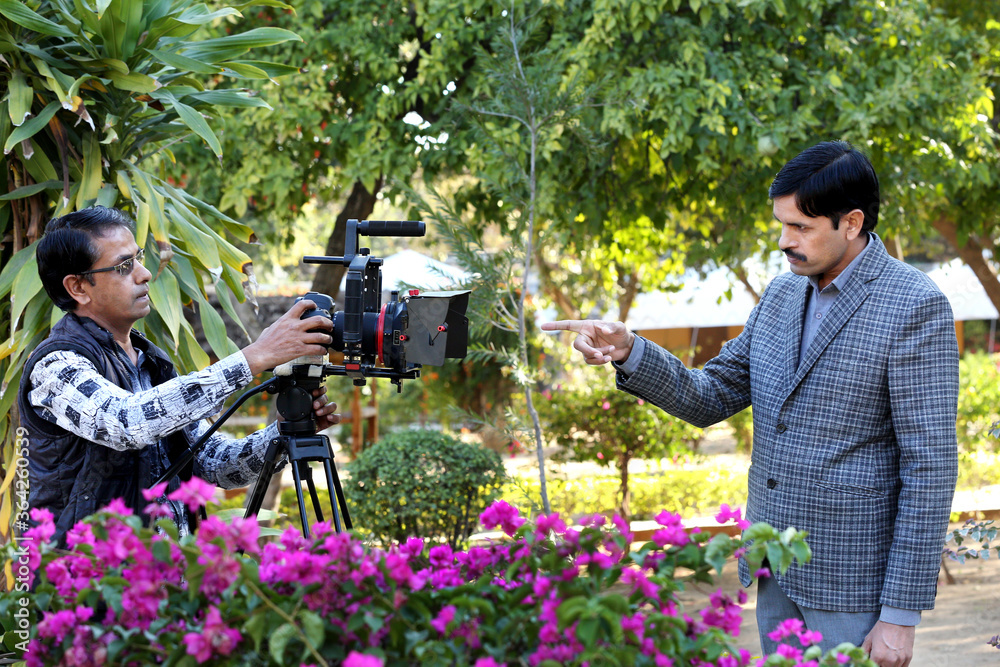 Professional Indian journalist and cameraman recording video interview ...