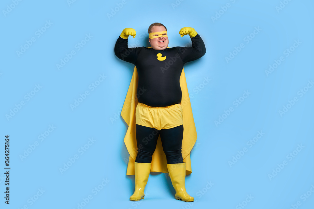 strong fat caucasian superhero man shows his muscles at camera, young ...