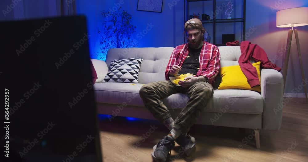Creepy zombie man sitting on sofa in the house at the Halloween party ...