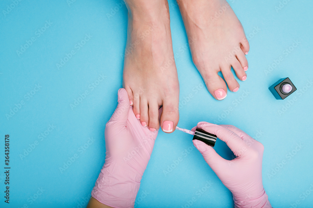 Specialist making french pedicure for client. Closeup young well ...