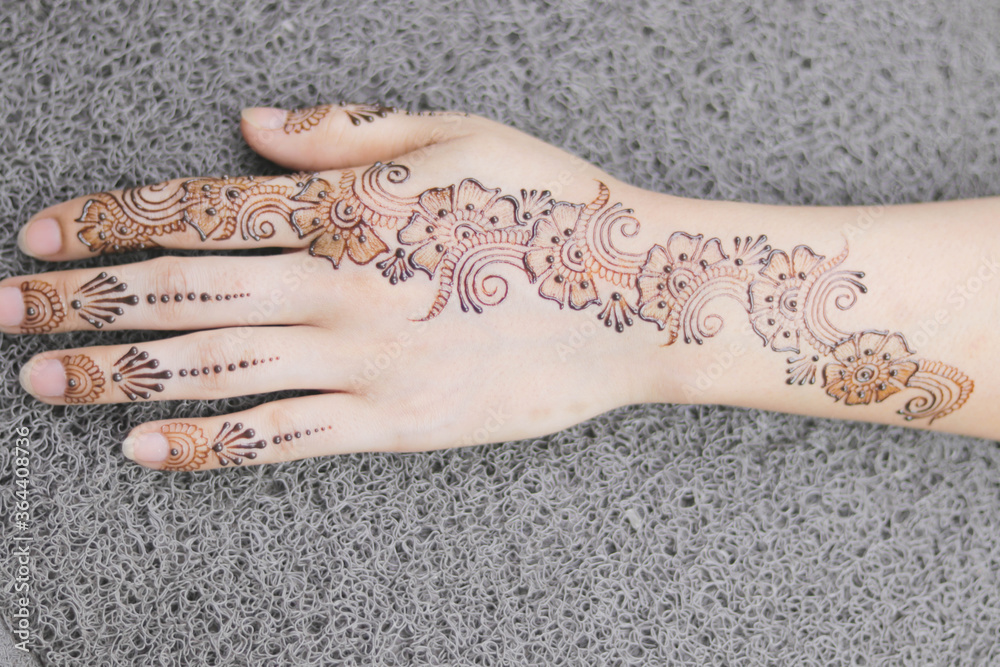 Carefully painted intricate design using henna, Mehndi art, on the hand ...