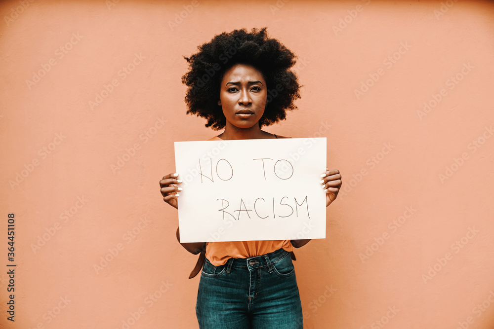 Attractive serious african woman standing and holding paper with NO TO ...