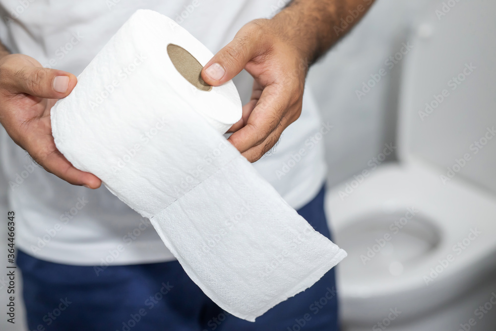 Man suffers from diarrhea hand hold tissue paper roll in front of ...