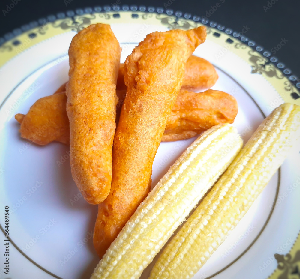 Delicious hot Baby corn baji with fresh baby corn placed in plate with ...