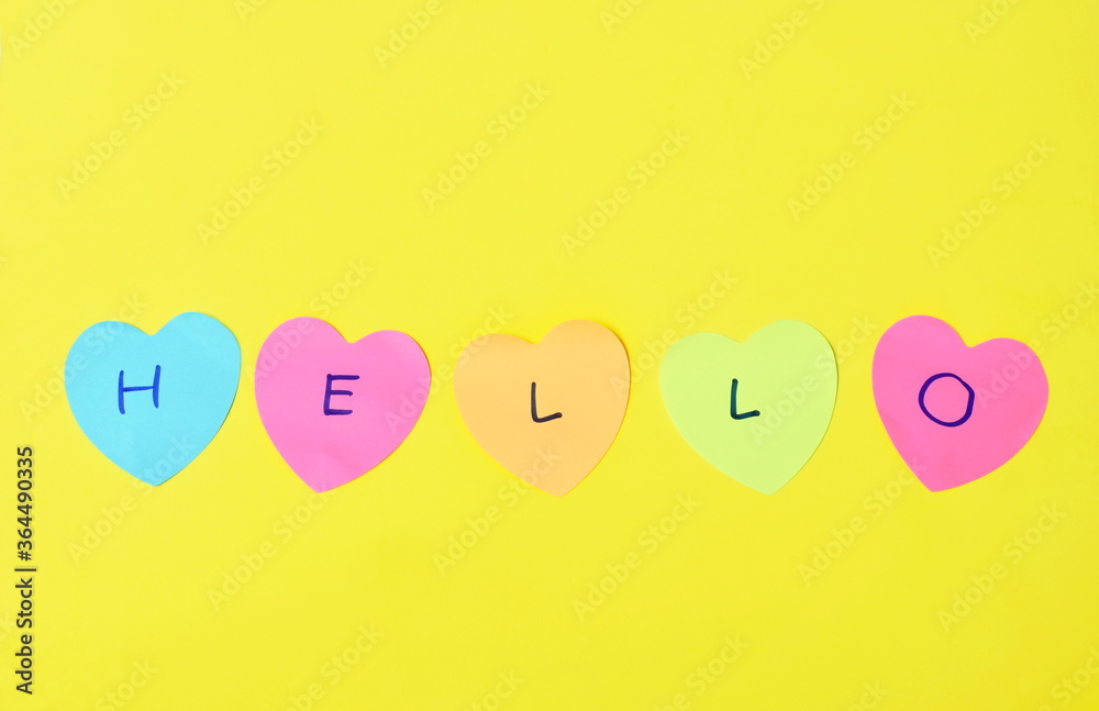 colorful sticky paper note with hearth shape write hello on yellow foam ...