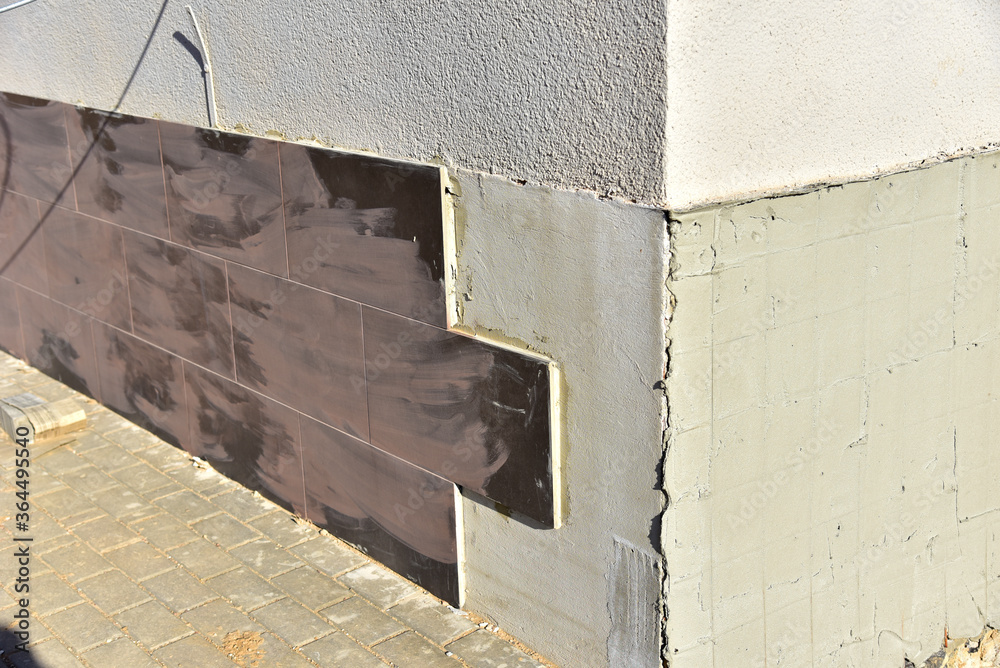 Insulation of walls cladding a ceramic tile. Modern metal facade tiles ...