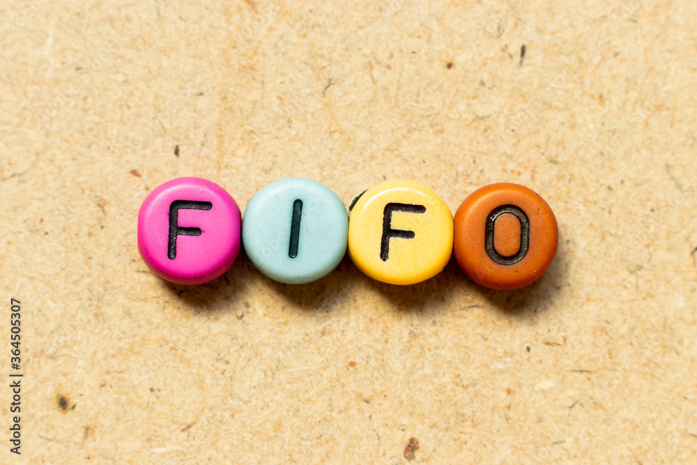 Round color bead with black letter in word FIFO (Abbreviation of first ...