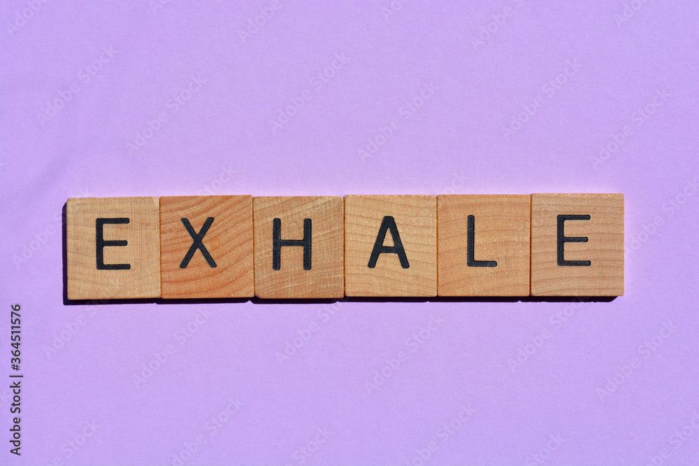 Exhale, word in 3D wooden alphabet letters isolated on purple ...