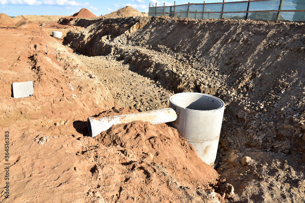 Laying concrete manholes and drain pipes for stormwater system ...